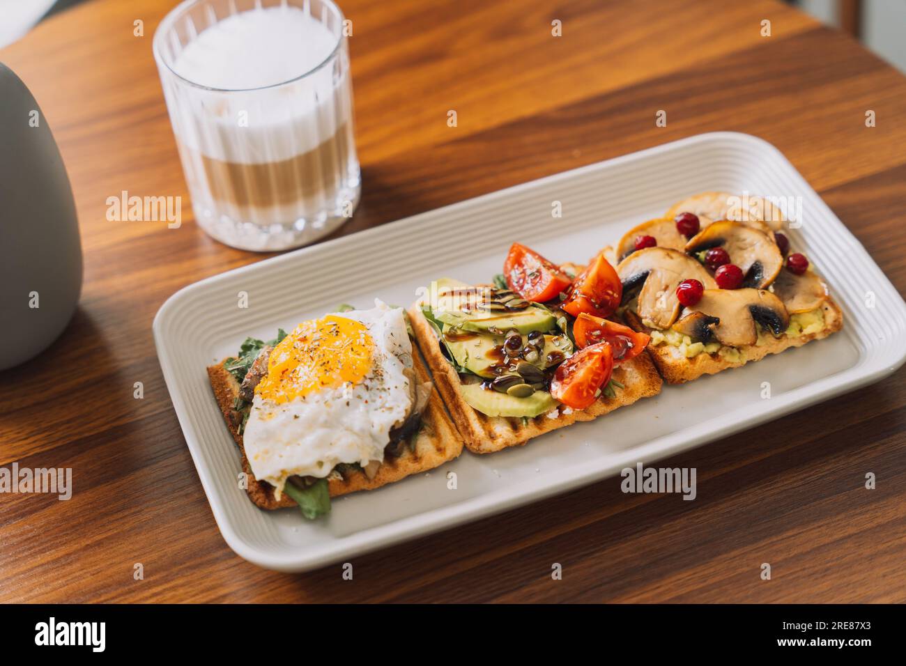 Breakfast toasts with different toppings with a cup of coffee Stock ...