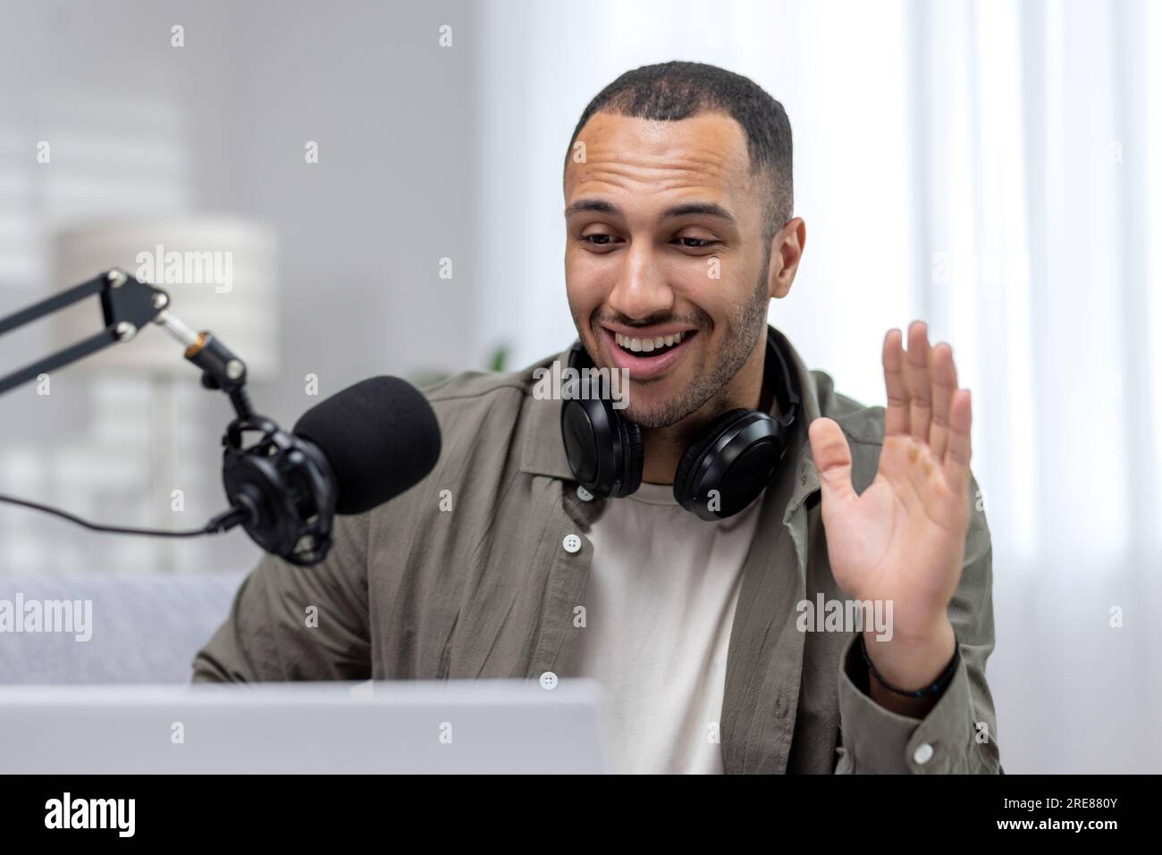 Close-up photo. Portrait of a young Latin American man working at home ...