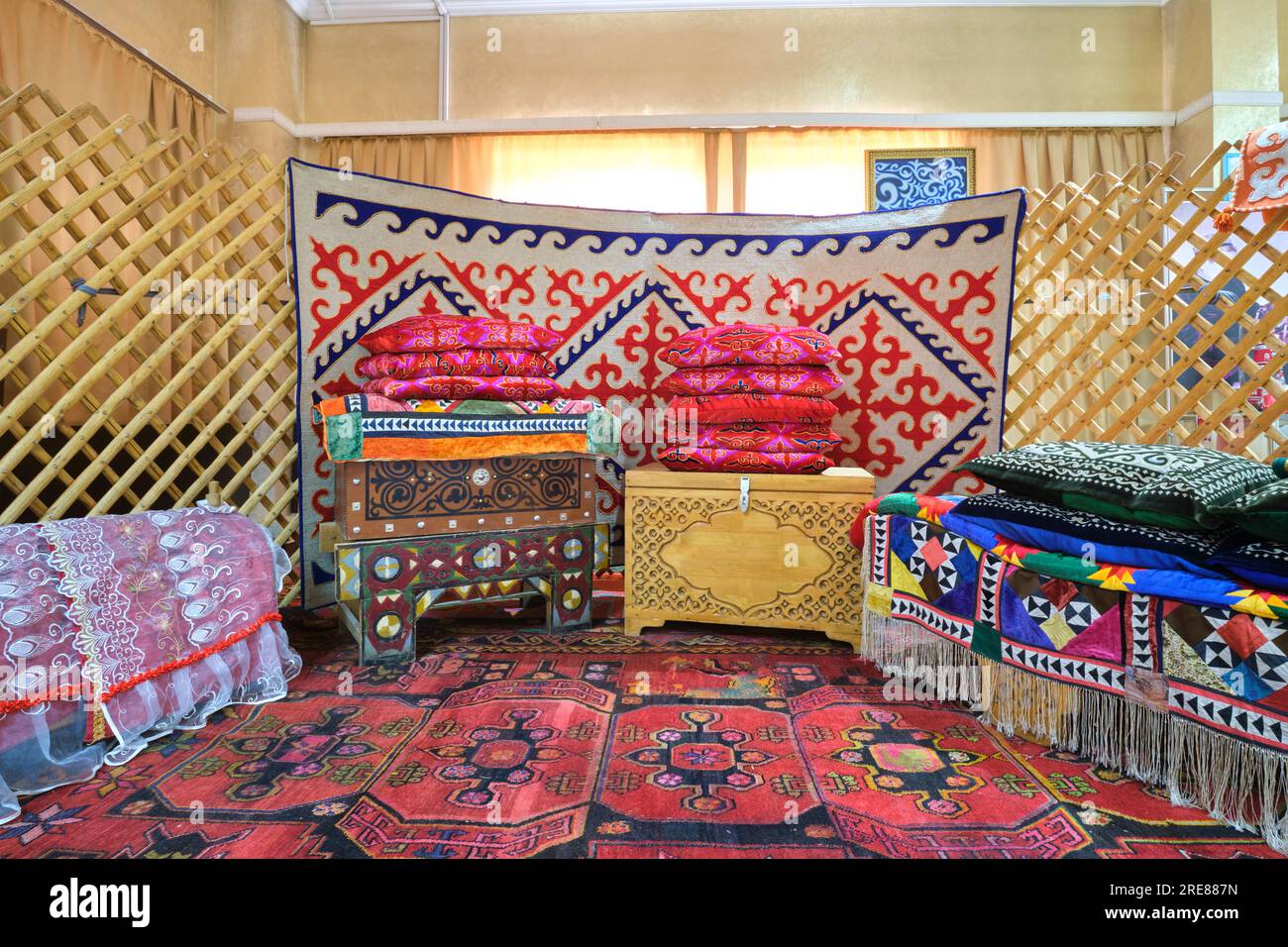 A display of various colorful rugs, blankets, textiles and carved wood ...