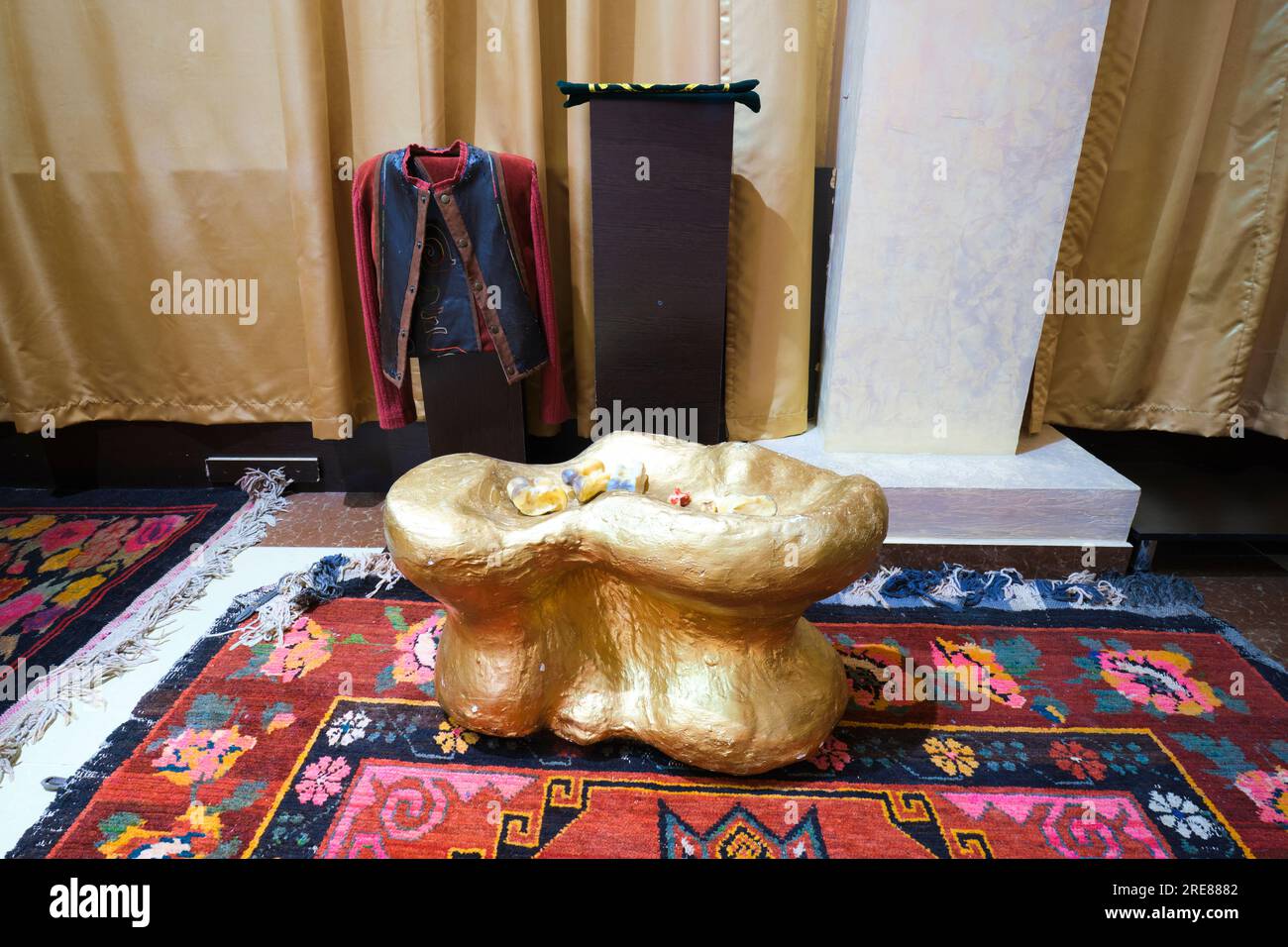 A display of a gold rock with player pieces, part of a traditional ...