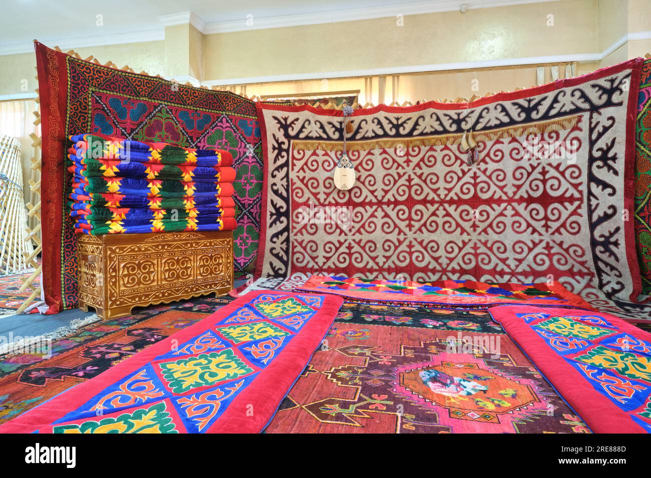 A display of various colorful rugs, blankets, textiles. At the local ...