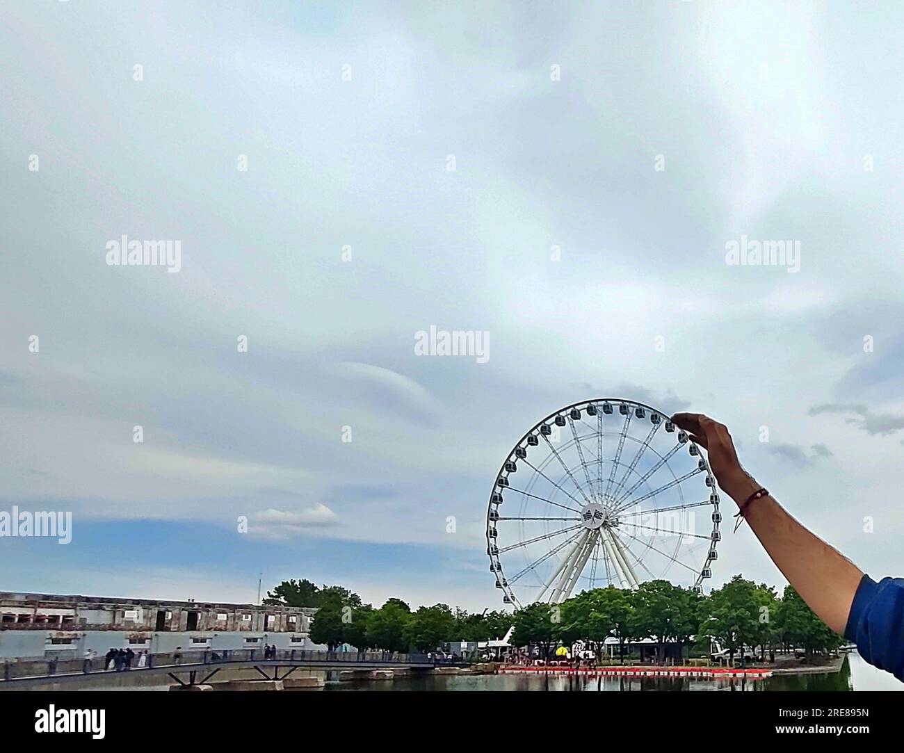 Photograph of a young boy pretending to touch the La Grande Roue de ...