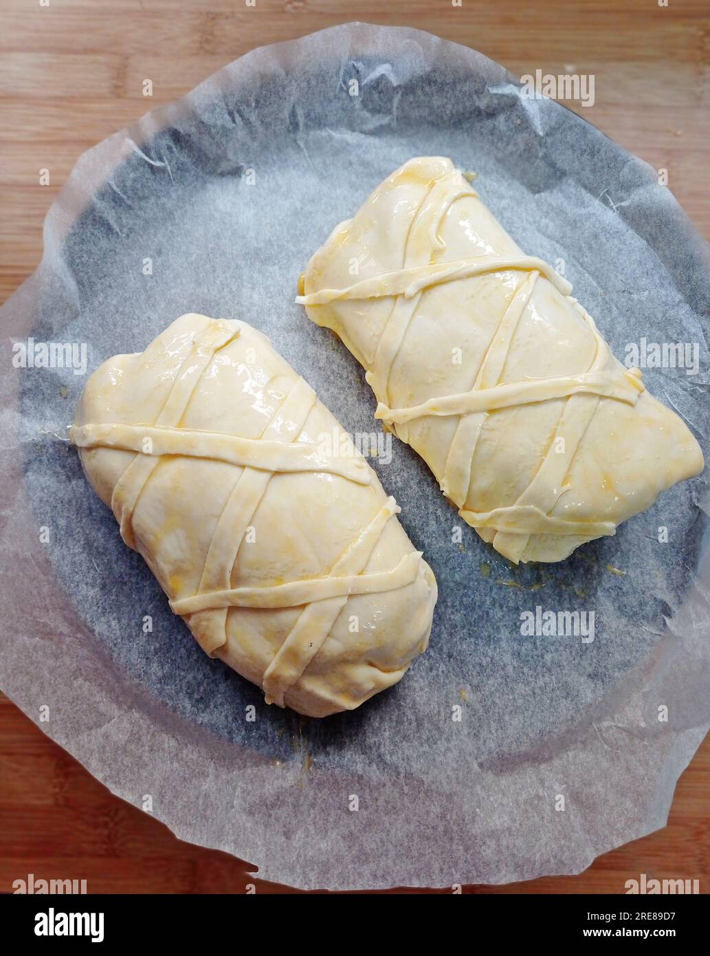Overhead view of two stuffed puff pastry parcels ready to cook Stock ...