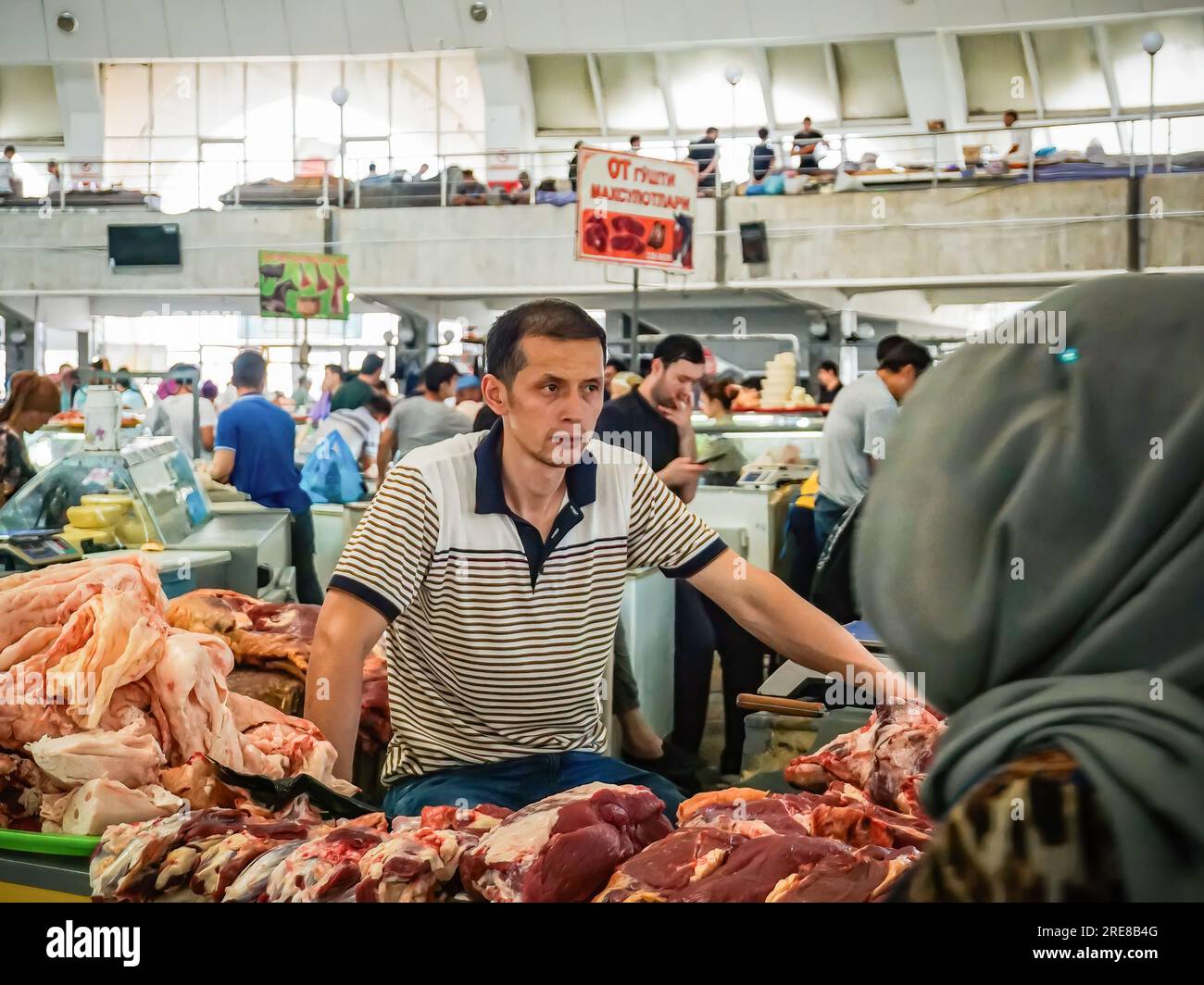 A salesman seen selling fresh meat inside the Chorsu Bazaar in Tashkent ...