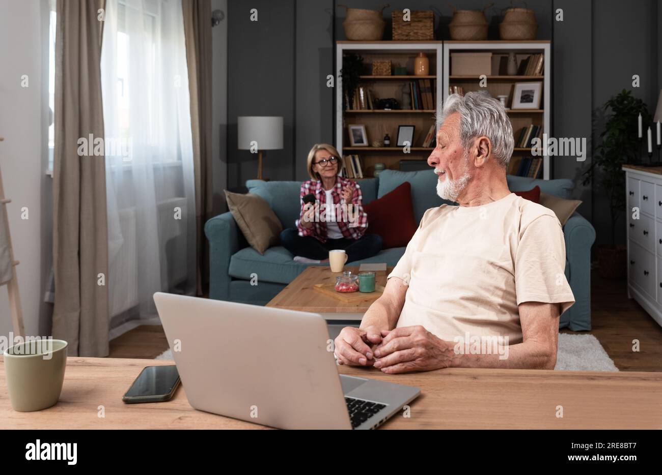 Senior couple argue at home while older retired military man trying to ...