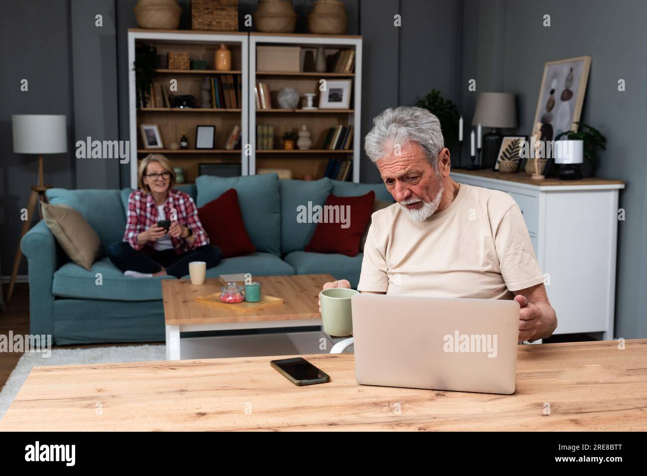 Senior couple argue at home while older retired military man trying to ...
