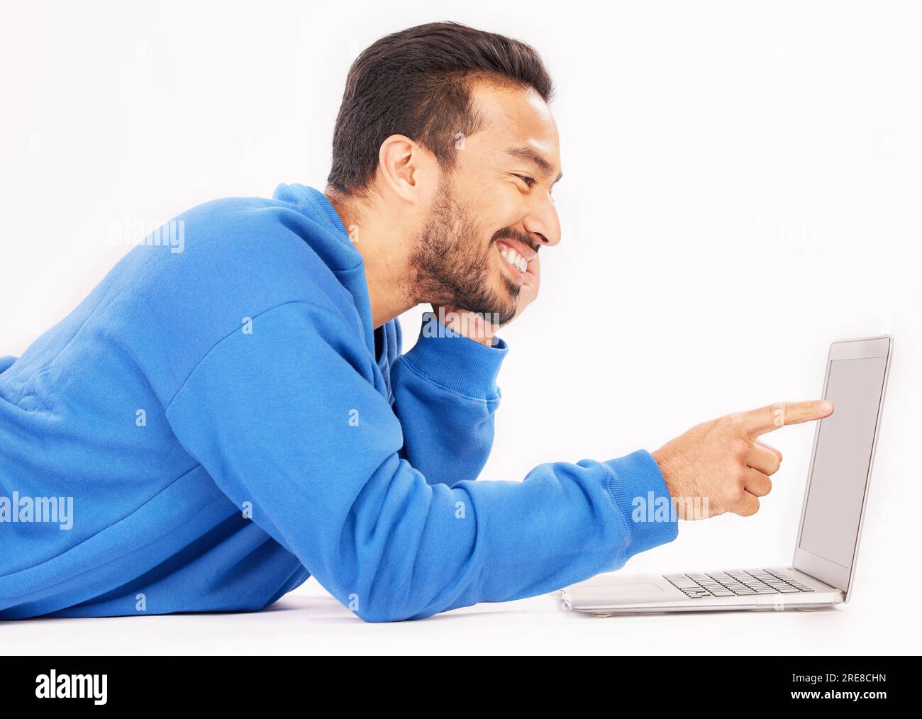 Smile, laptop and man pointing on studio floor isolated on a white ...