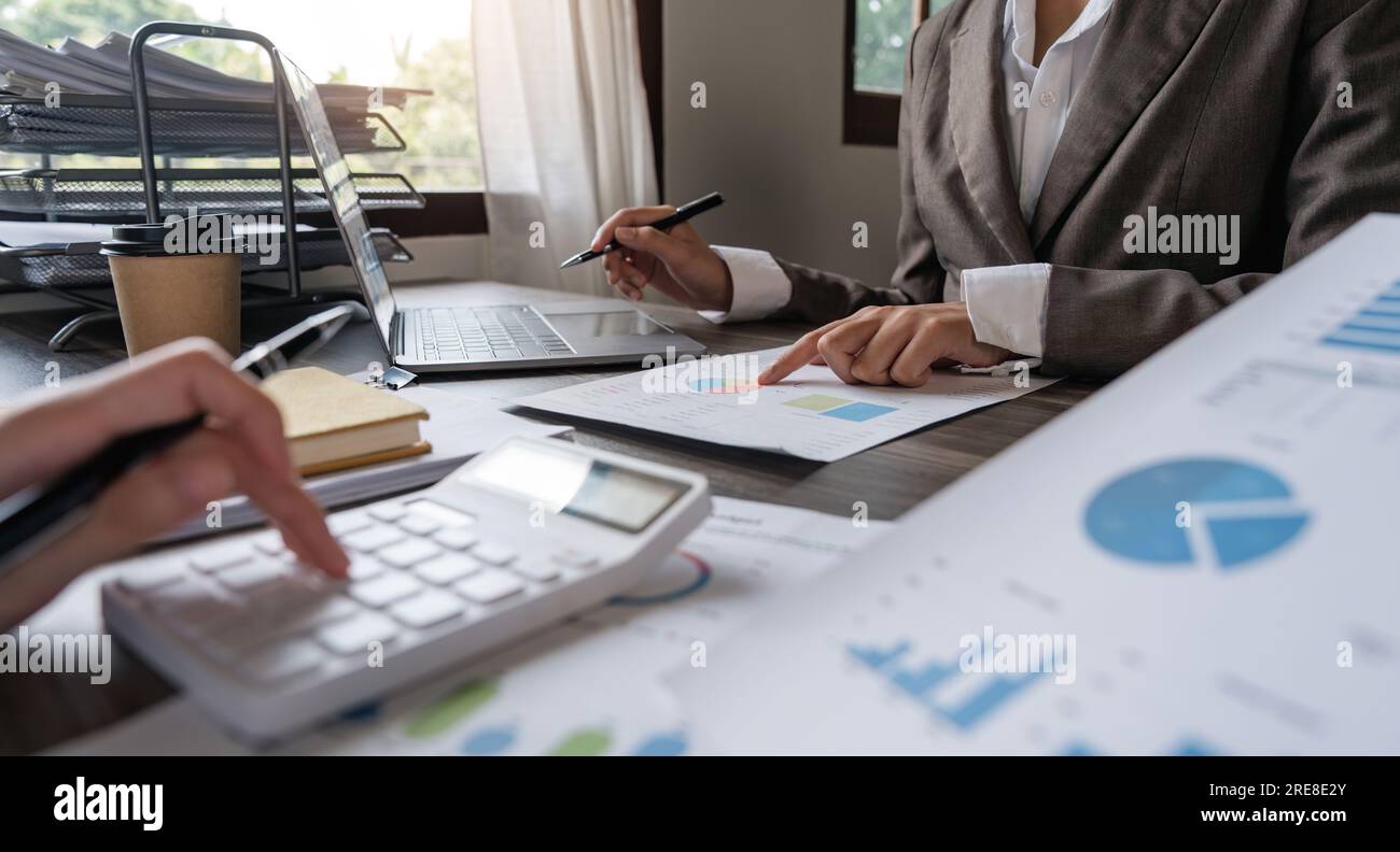 Team work process Business team use calculator to calculate figures ...