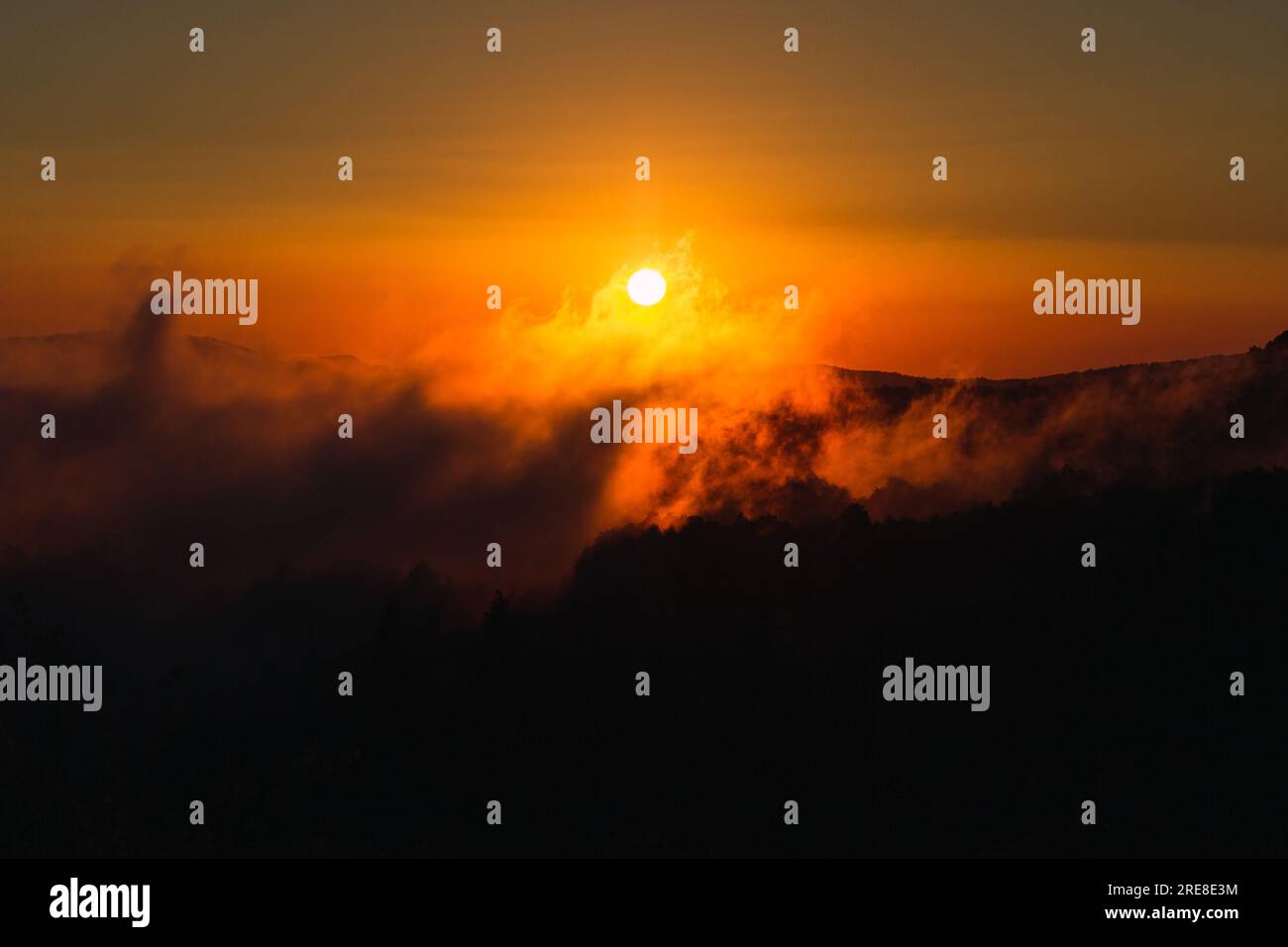 sunset between mountains and fog Stock Photo - Alamy