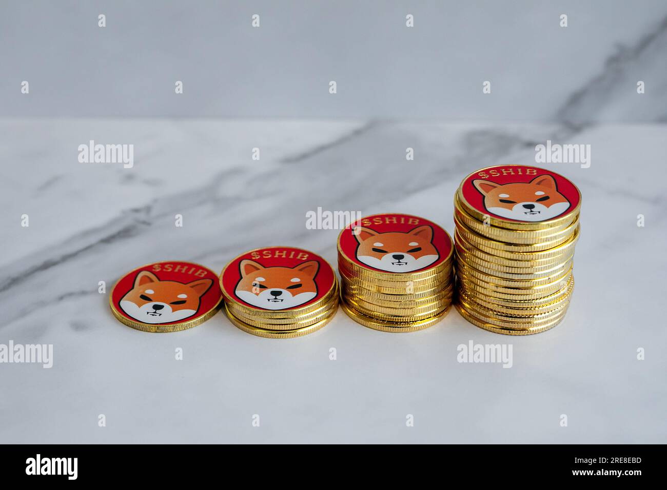 Shiba inu coins (SHIB) are sorted from small to large with a white ...
