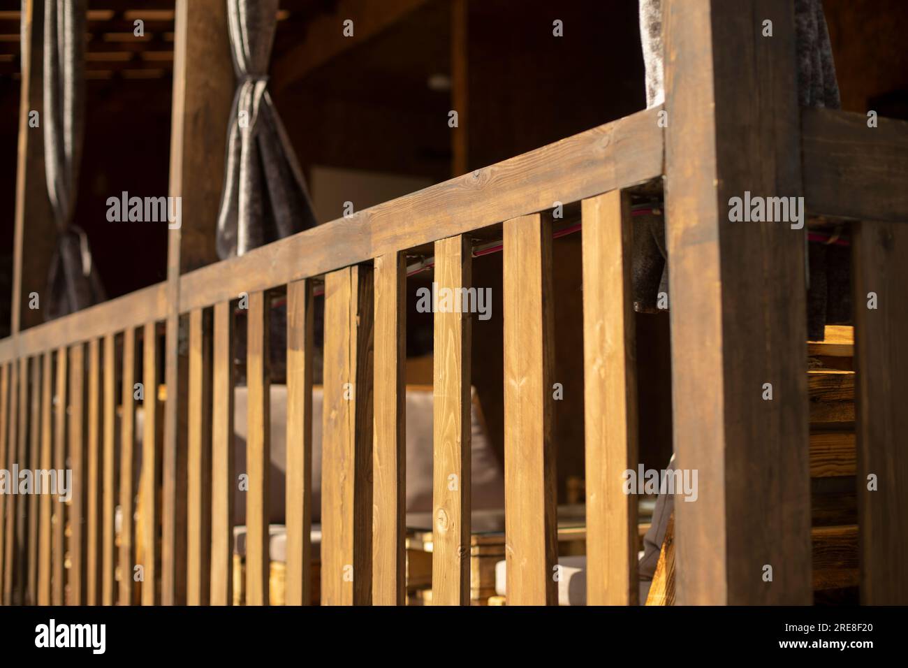 Veranda made of wood. Fence from boards. Street restaurant. Brown fence ...