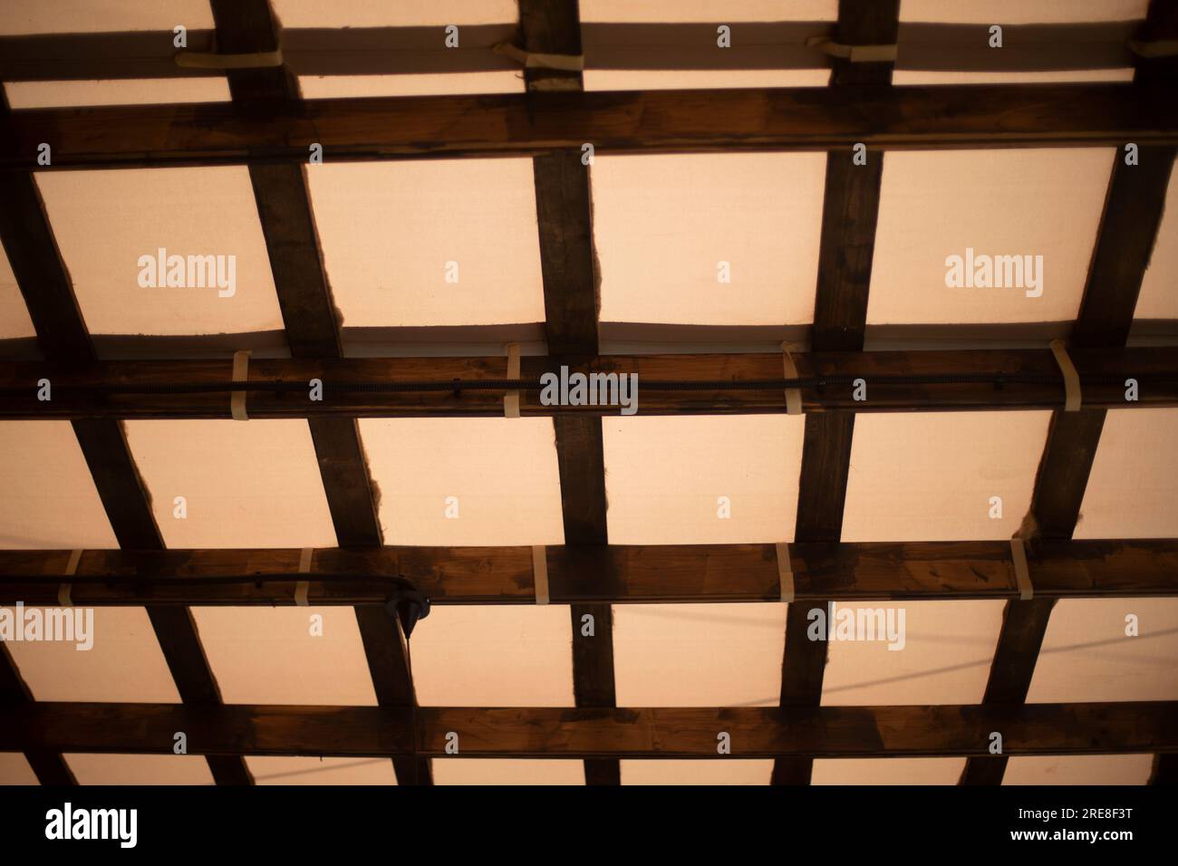 Roof inside. Roof made of planks. Interior details. Ceiling in lattice ...