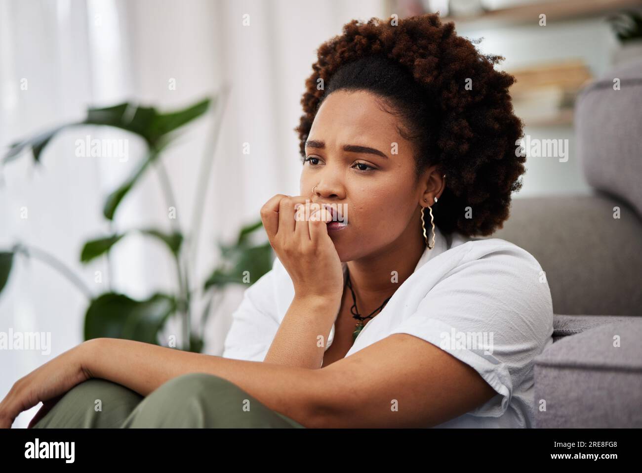 Depressed, sad and african girl in home with anxiety for future with ...