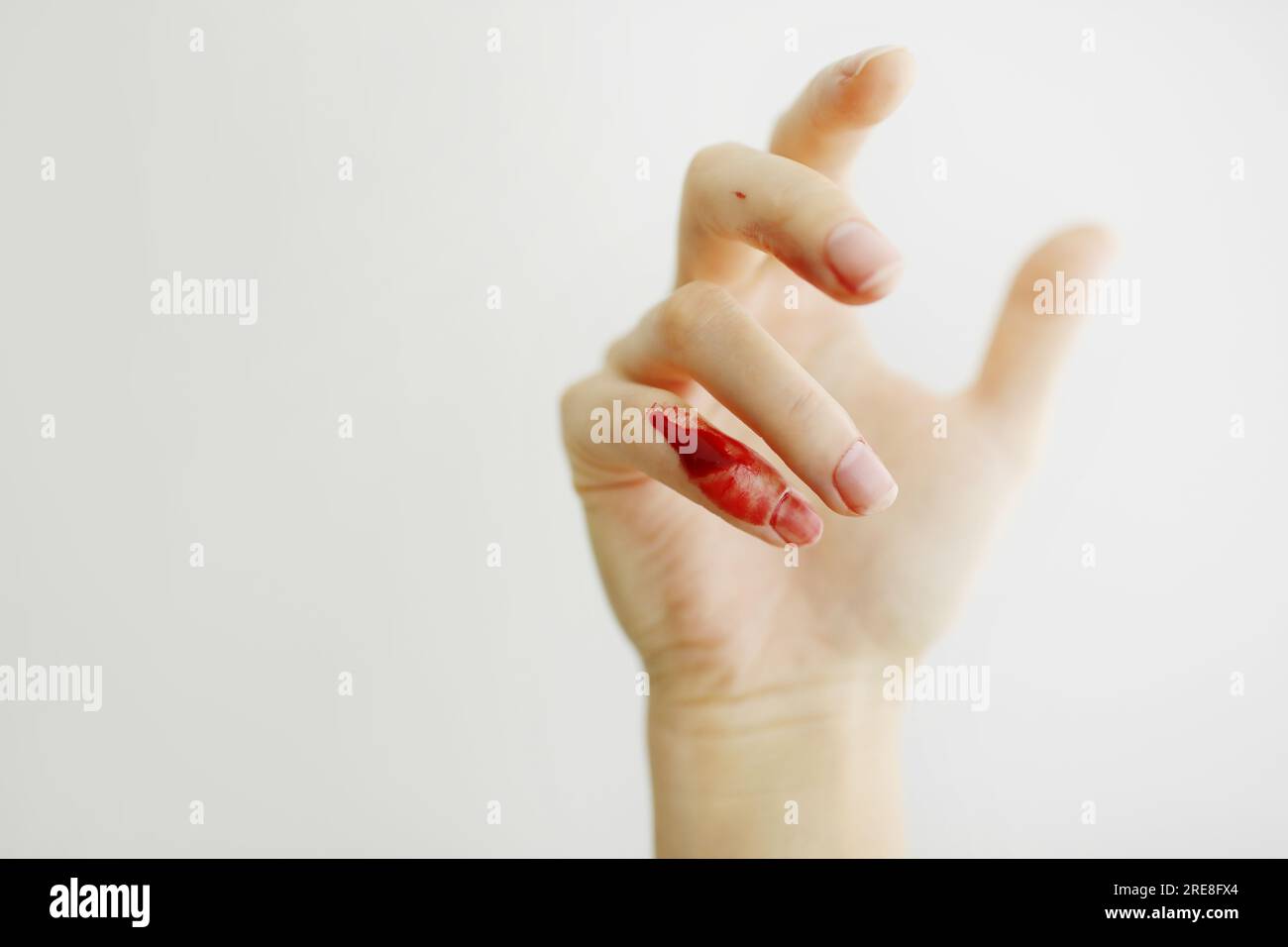 Female hand with red blood, little finger is bleeding profusely. Woman ...