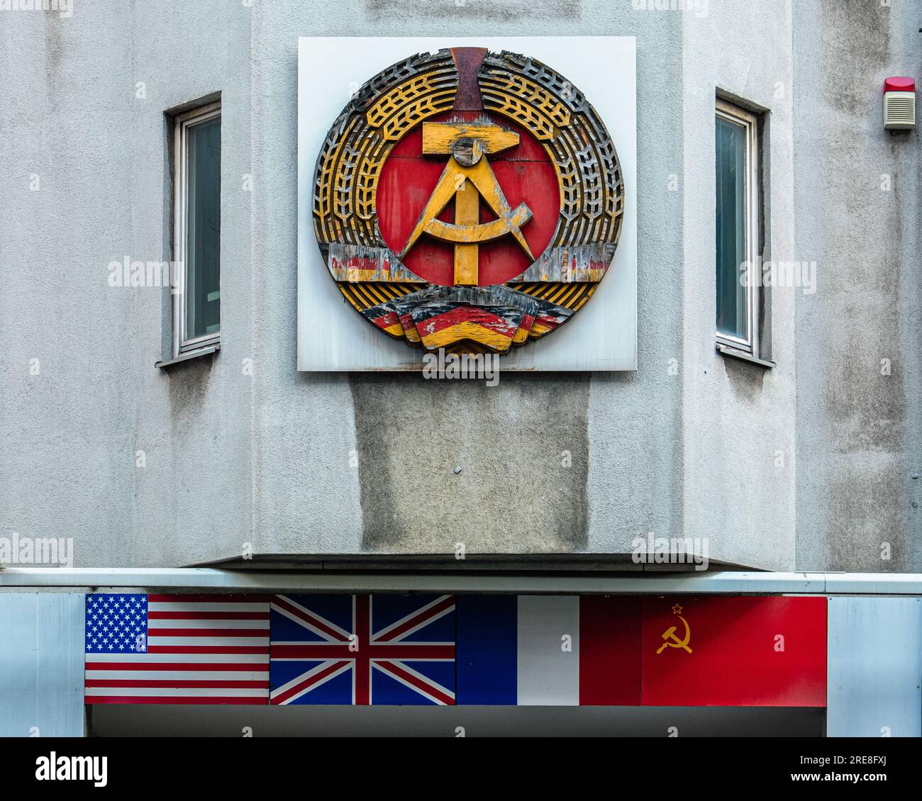 GDR emblem & Allied flags outside Checkpoint Charlie Museum in ...