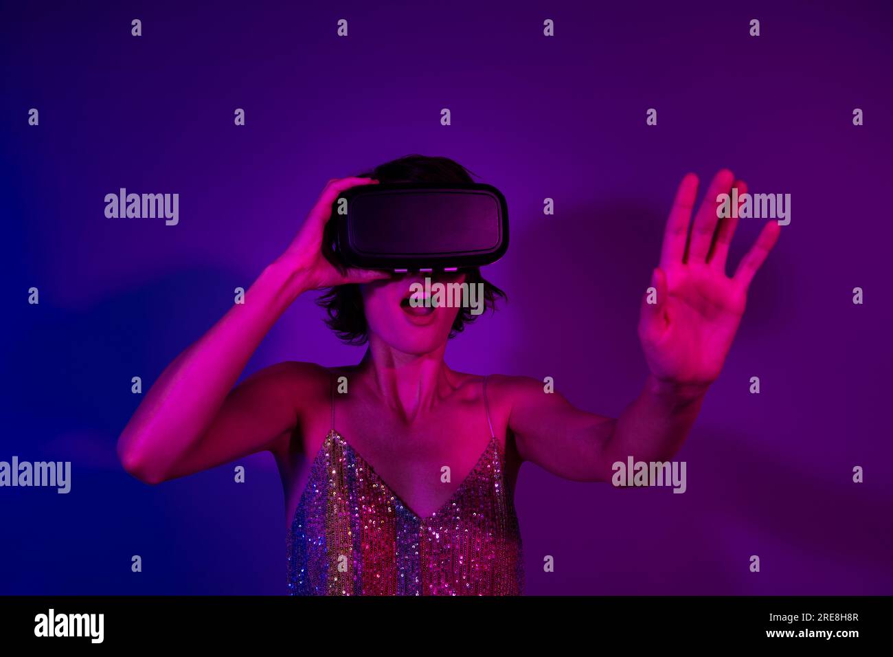 Photo of lady playing simulation game vr box impressed surprise visual ...