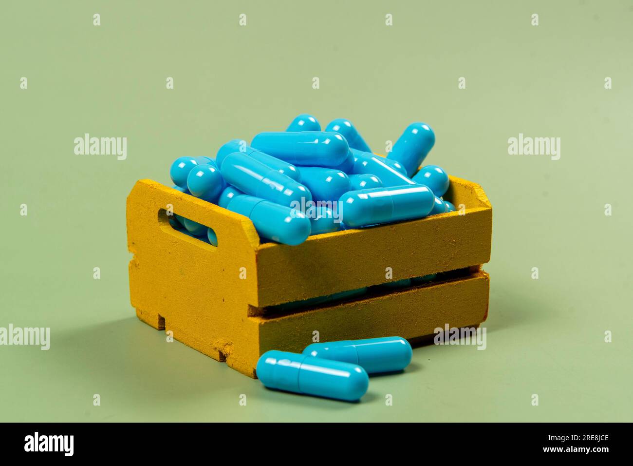 blue medicine capsule in yellow delivery box Stock Photo - Alamy