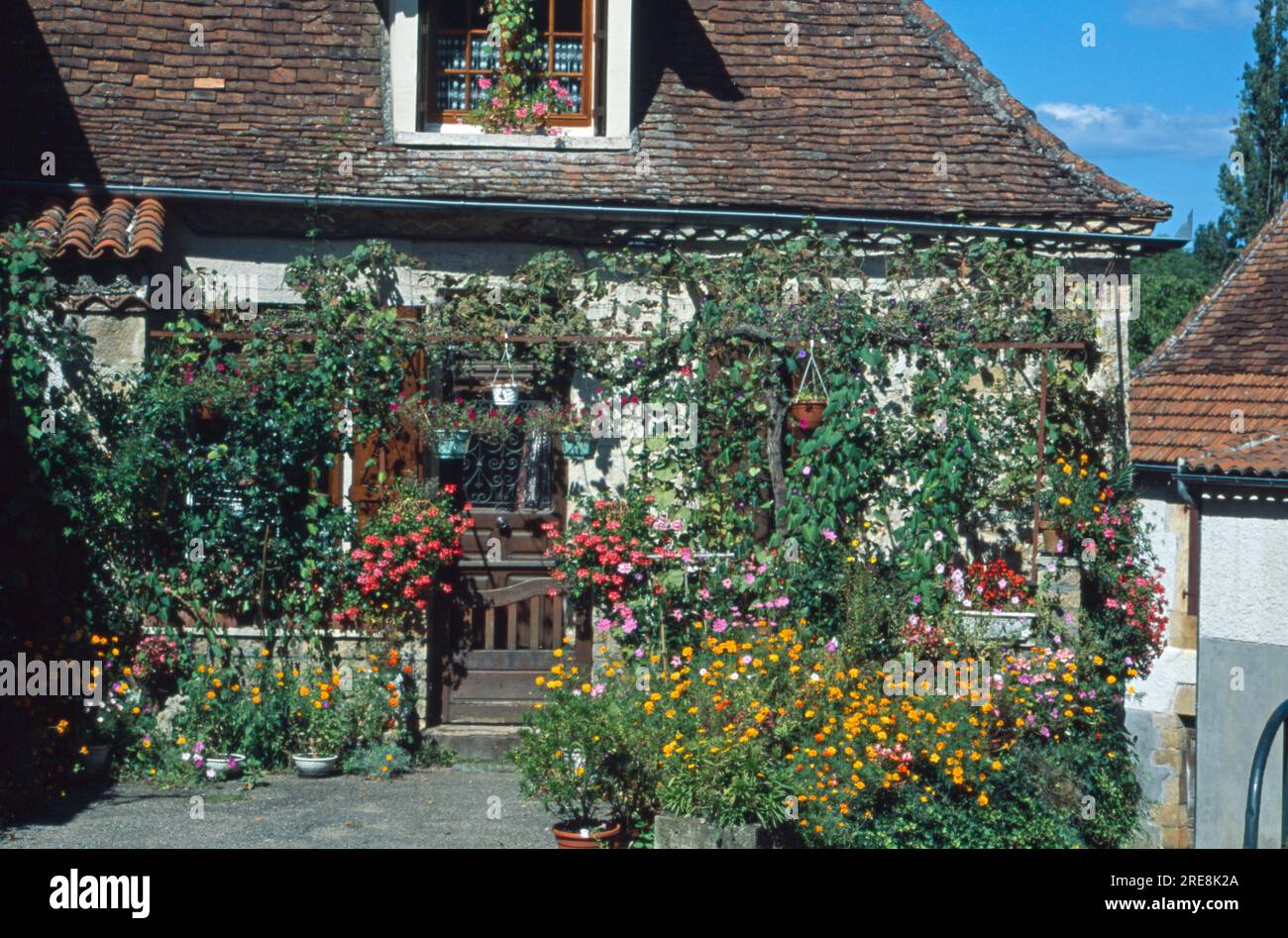 House and front garden in the village of Autoire, Dordogne and Lot ...