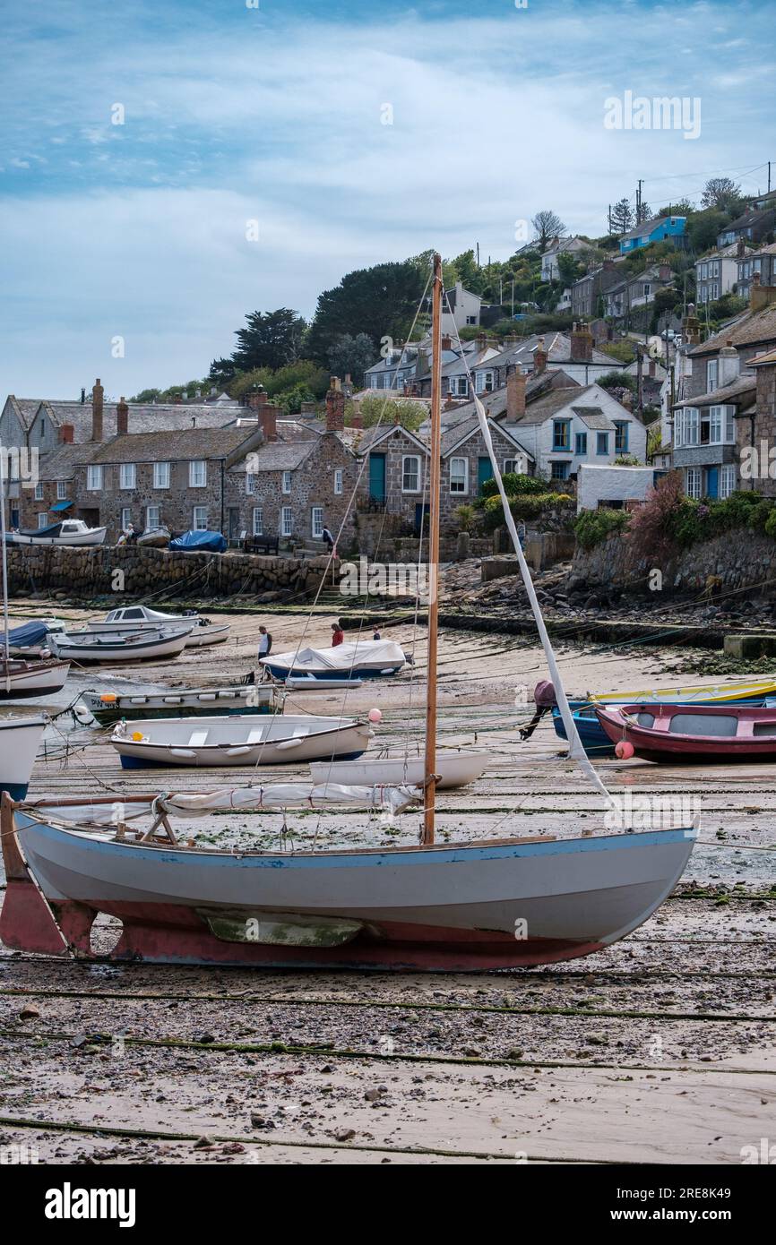 Quaint & charming Mousehole harbour at low tide with small boats ...