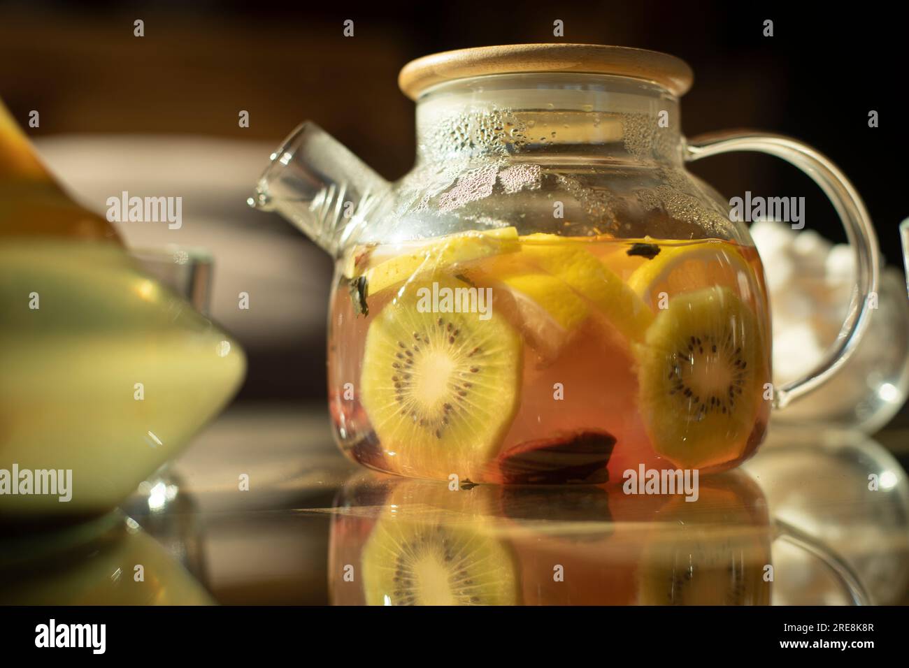 Fruit tea in teapot. Kettle on table. Fruits in summer. Healthy drink ...