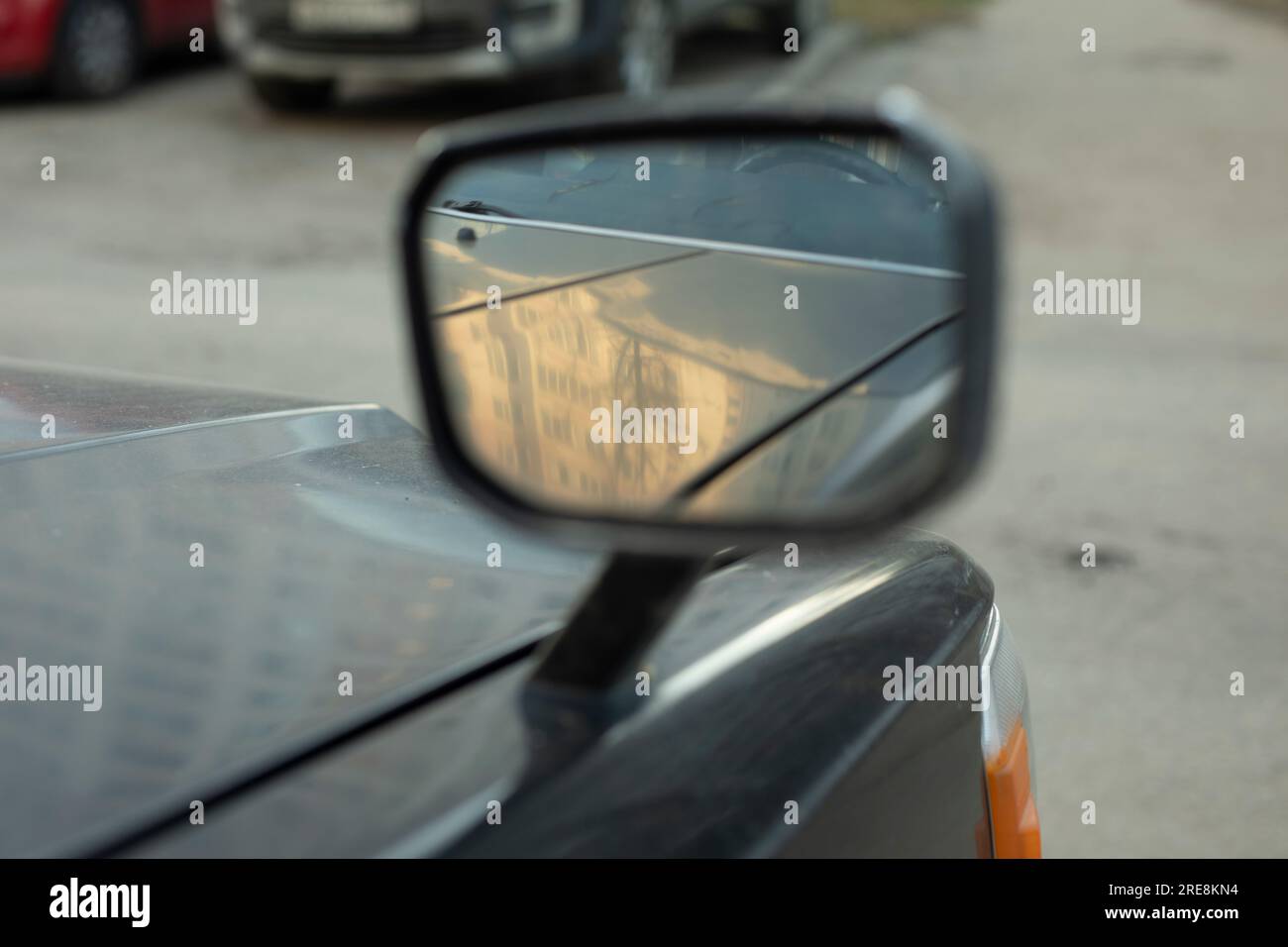 Rear view mirror. Mirror on car is mounted on hood. Overview for driver ...