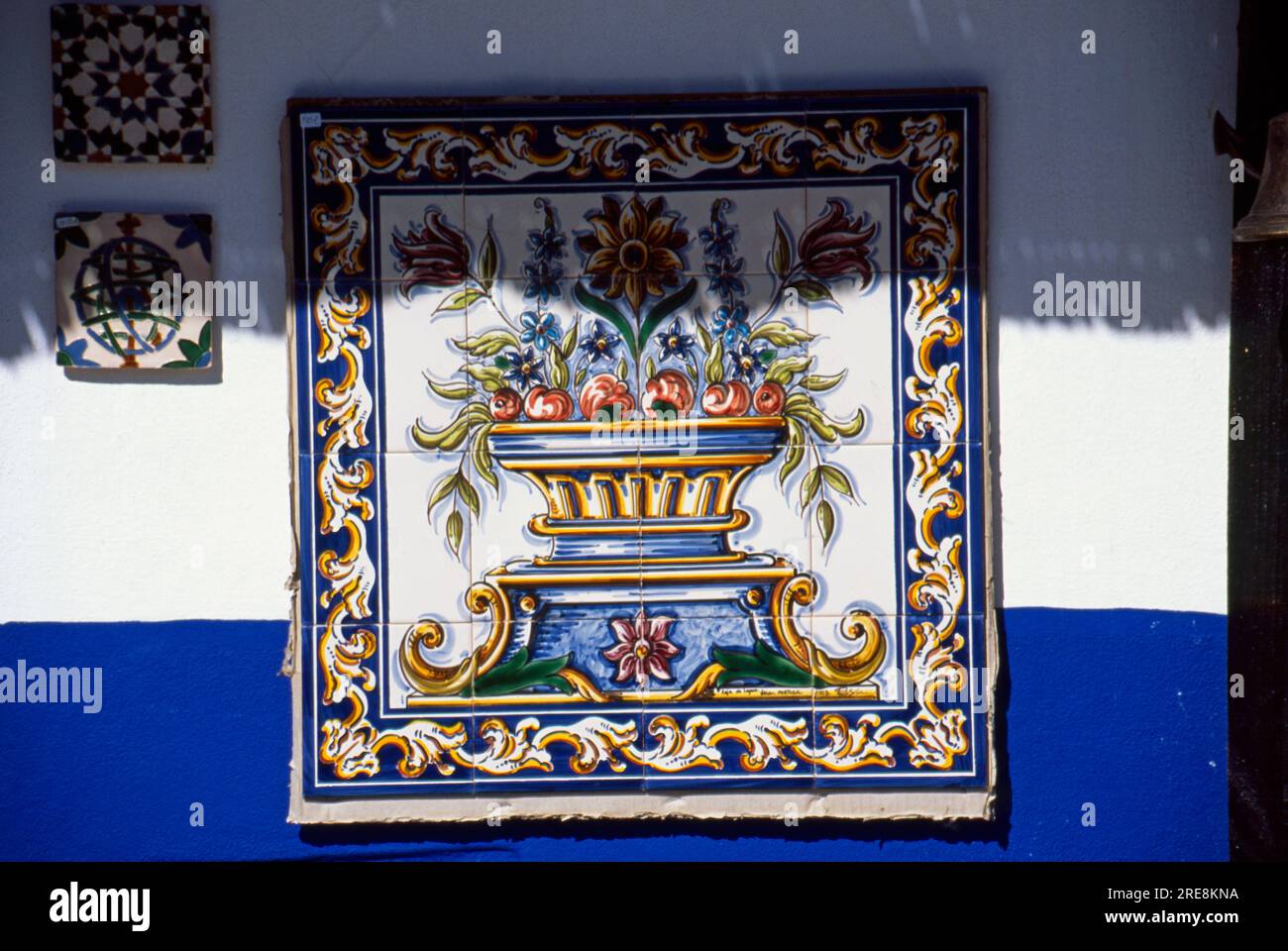 Traditional tile wall frieze showing a vase with fruit and flowers ...