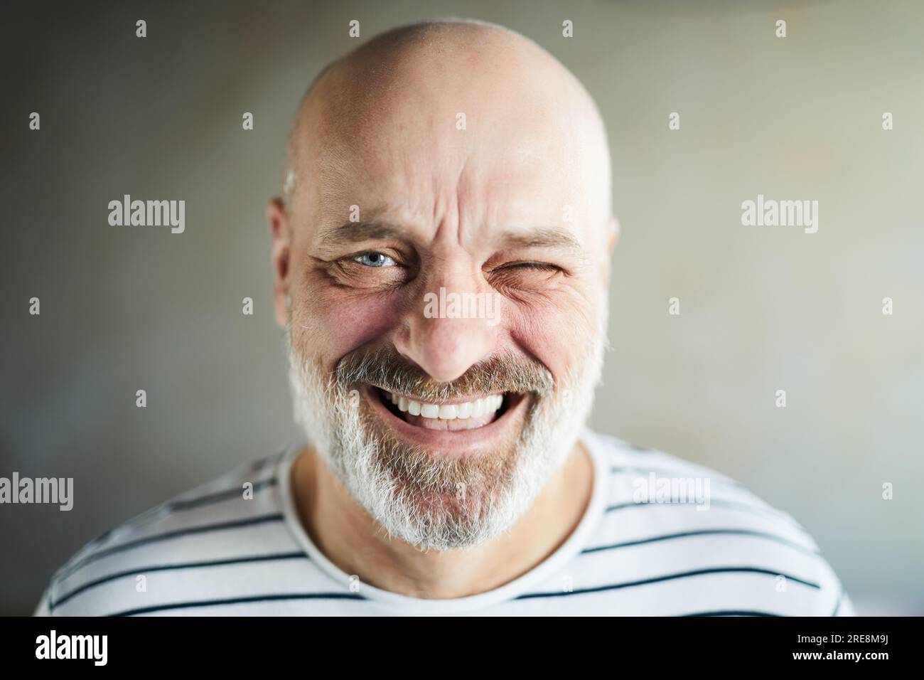 Portrait of excited emotional bald mature man with gray beard and ...
