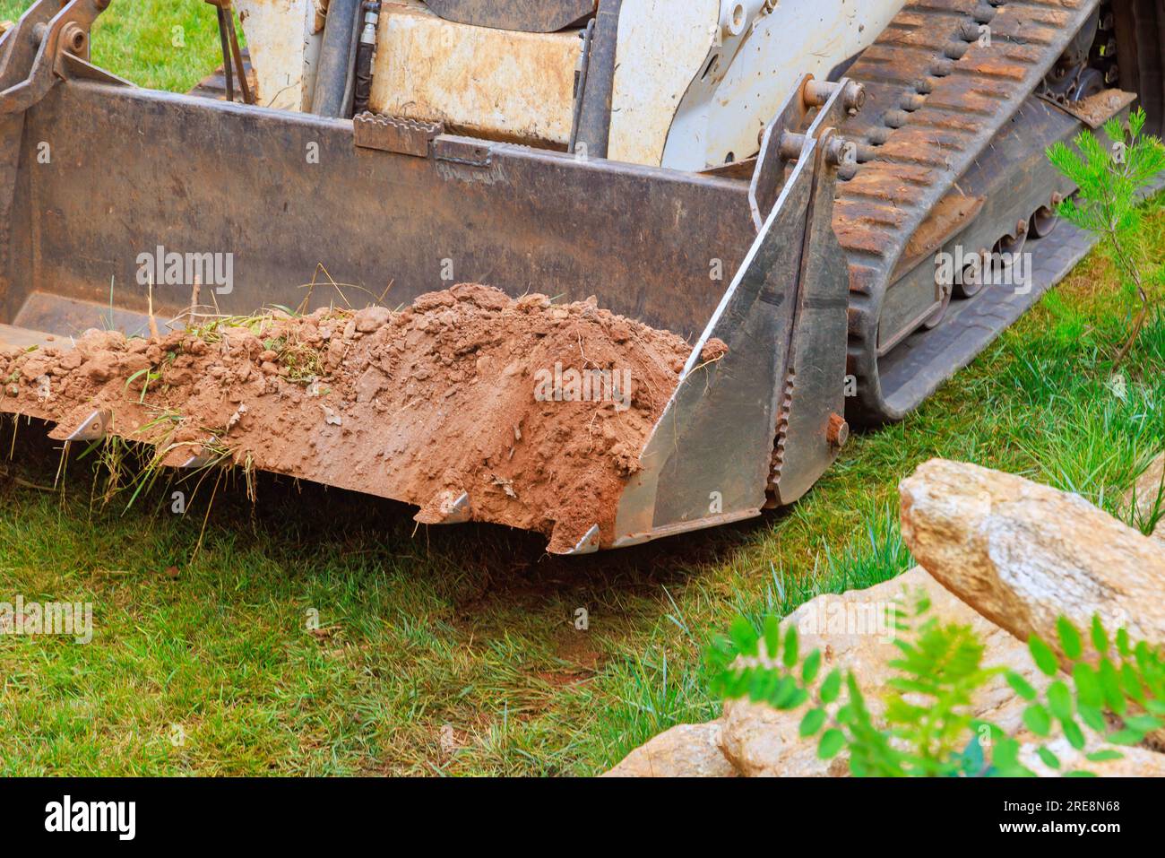 Mini bulldozer is efficiently working with earth, carrying out various ...