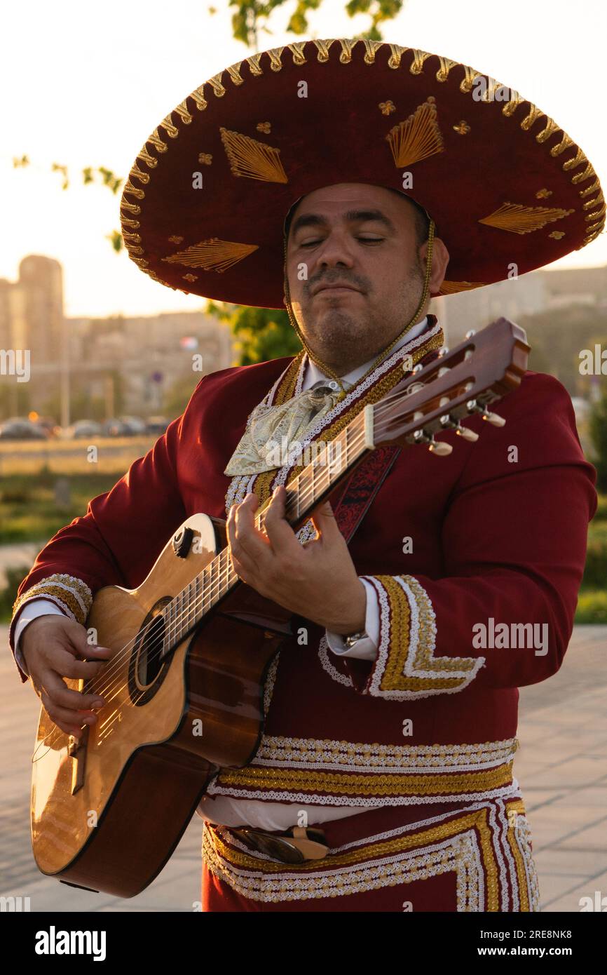 Mexican musician mariachi plays the guitar on a city street Stock Photo ...