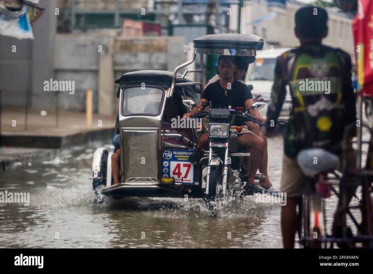 Malabon City, Philippines. 26th July, 2023. People wade through a water ...