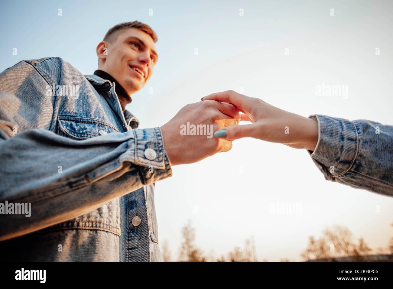 gentle boy holding girl's hand tenderly in a heartwarming gesture Stock ...