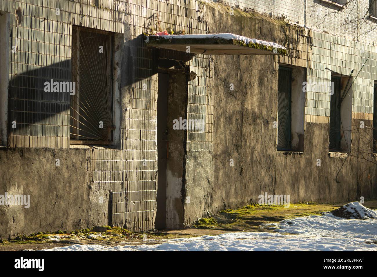 Back entrance to building. Old building. Visor above entrance. Black ...