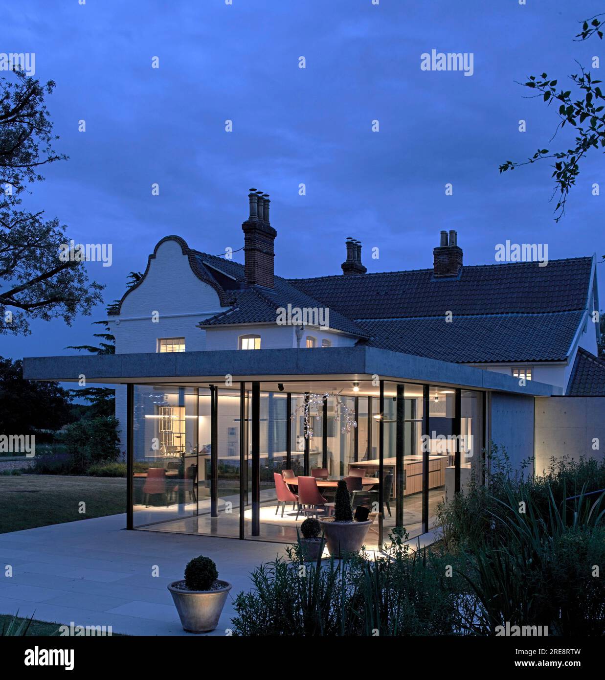 Dusk view. Listed Farmstead, Suffolk, United Kingdom. Architect: Rodic ...