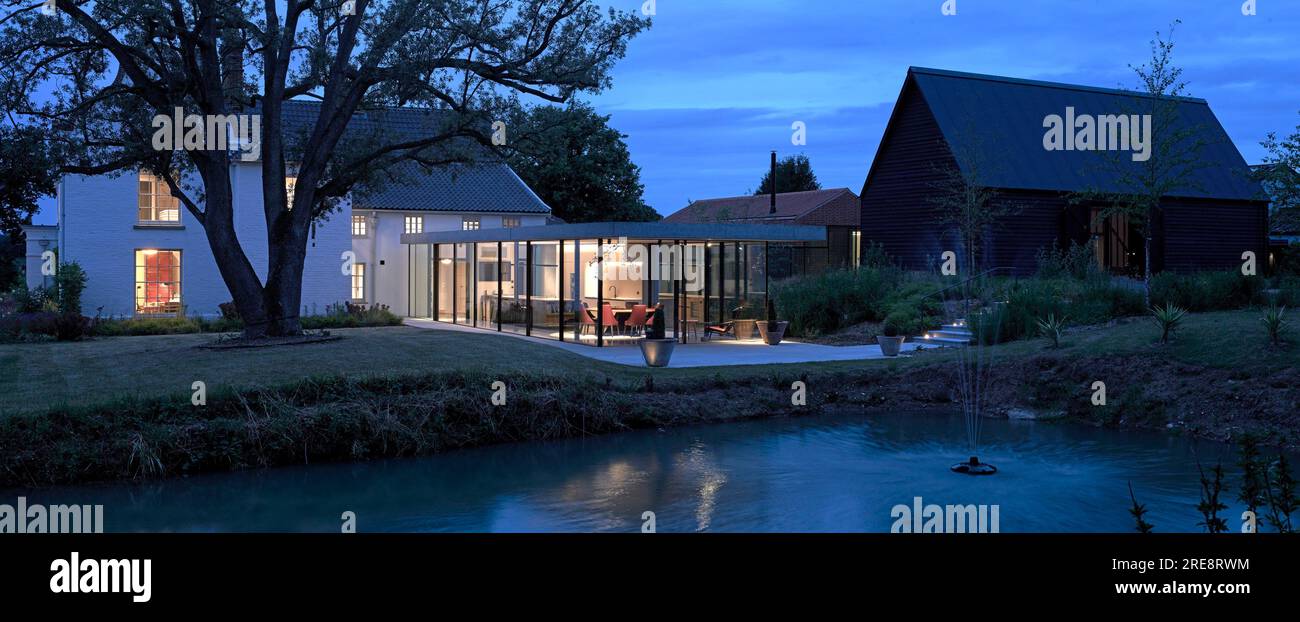Dusk view. Listed Farmstead, Suffolk, United Kingdom. Architect: Rodic ...