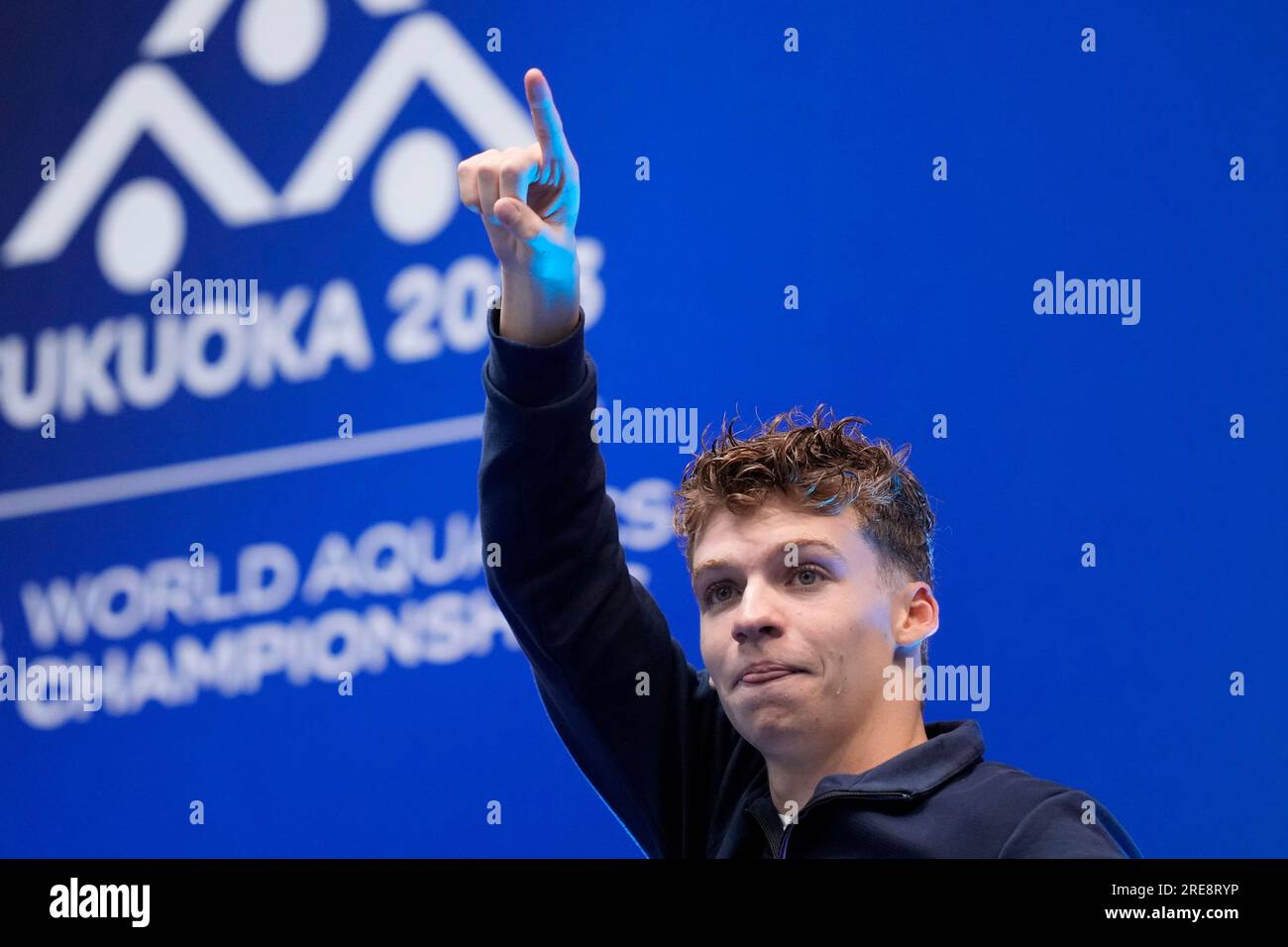 Gold medalist Leon Marchand of France celebrates on the podium during ...