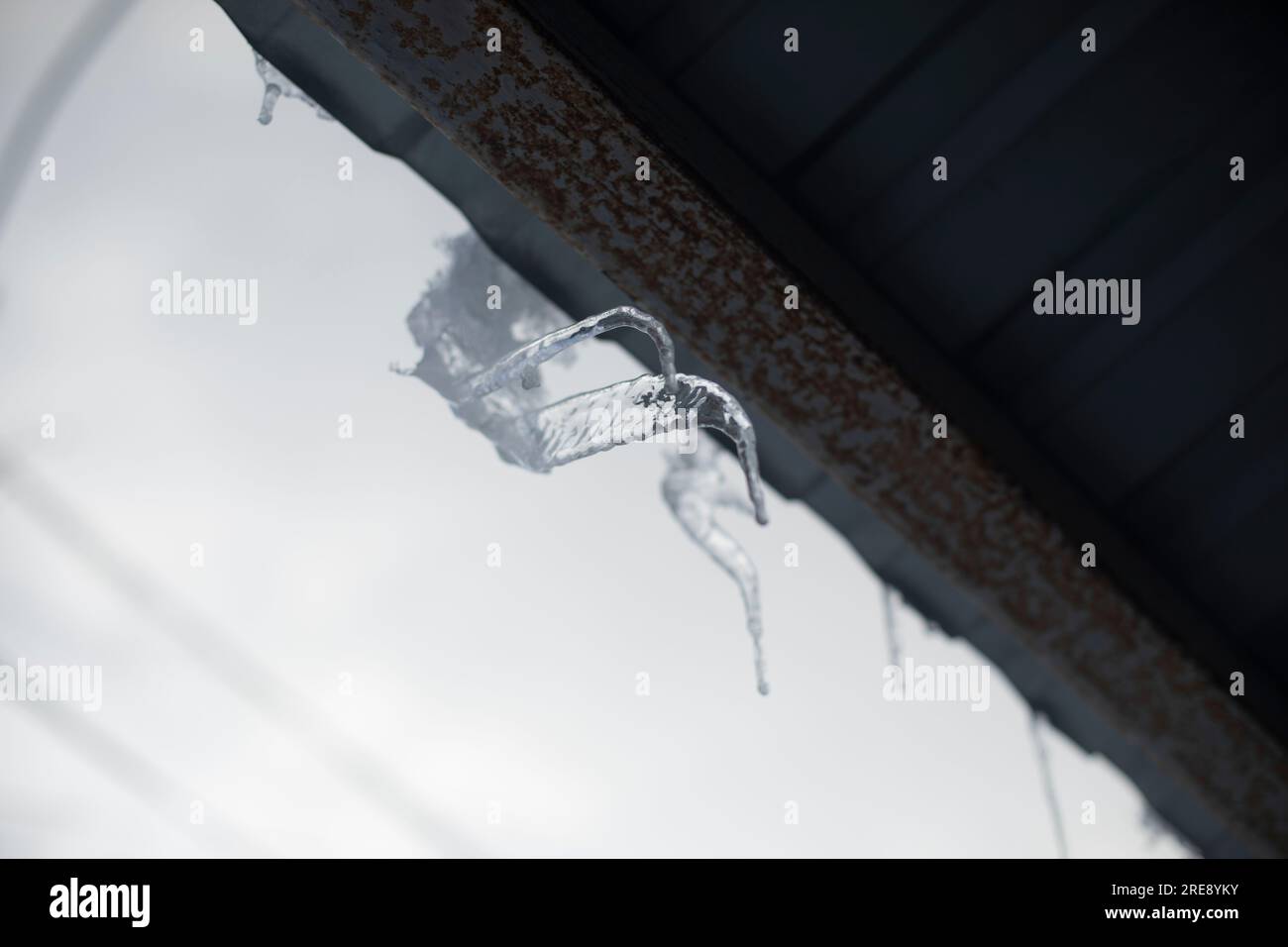 Ice on goat of roof. Icicles on roof. Ice on house. Melting snow Stock ...