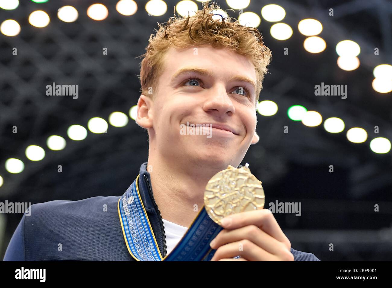 Fukuoka, Japan. 26th July, 2023. Leon Marchand of France shows the gold ...