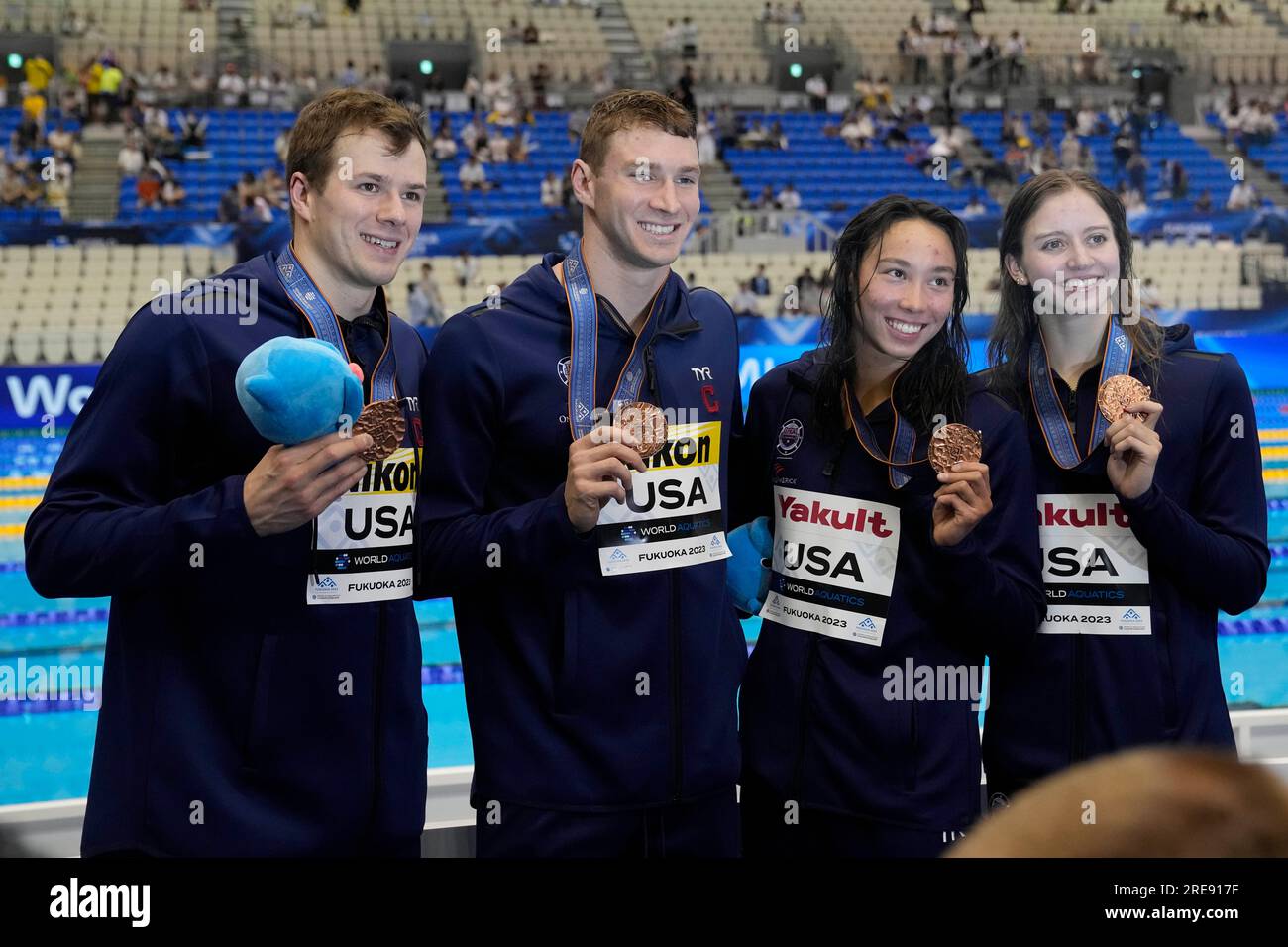 Team U.S. celebrate with their bronze medals after the mixed 4x100m ...