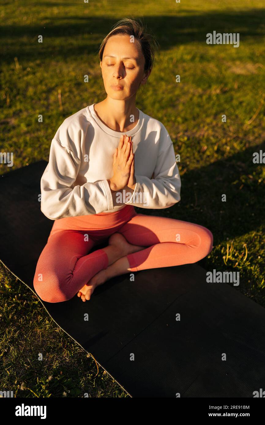 Vertical portrait of serene yogini female practicing yoga performing ...