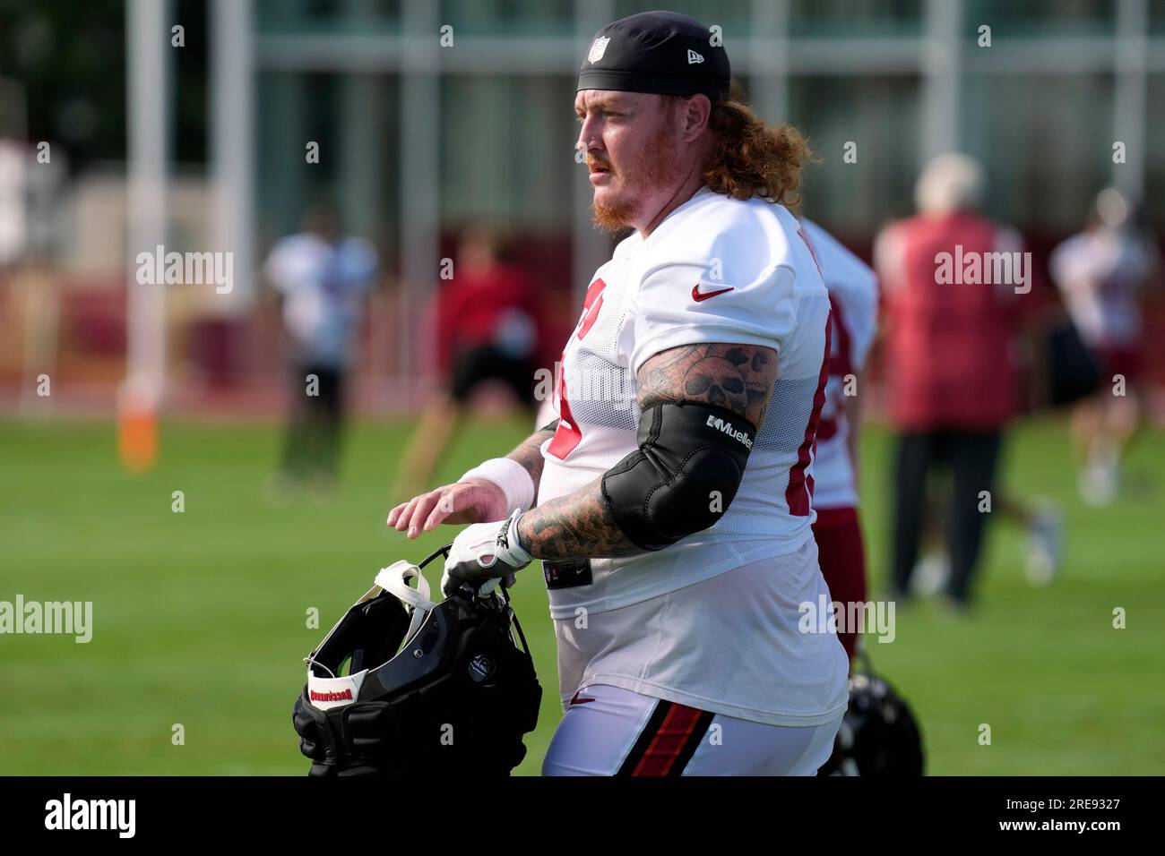 Tampa Bay Buccaneers center Ryan Jensen carries his helmet during an ...
