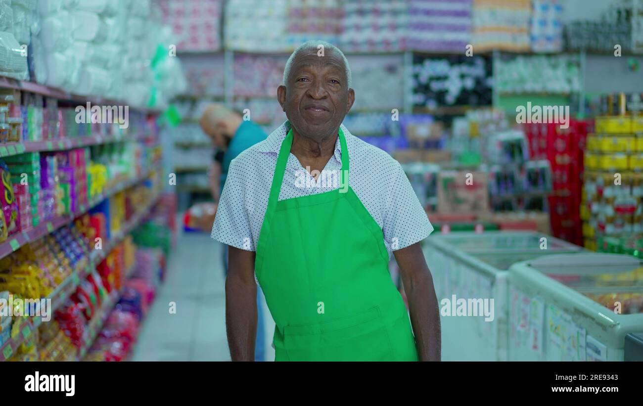 Portrait of a Black Brazilian senior employee of Grocery Store standing ...