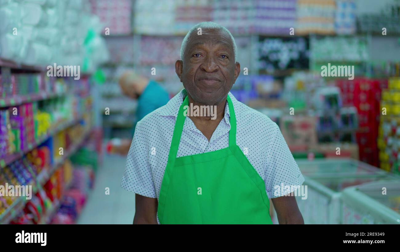 Portrait of a Black Brazilian senior employee of Grocery Store standing ...