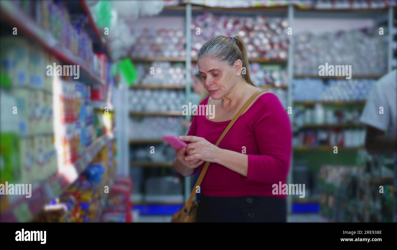 Female Shopper Cross-Checking Product Details Online Using Smartphone ...