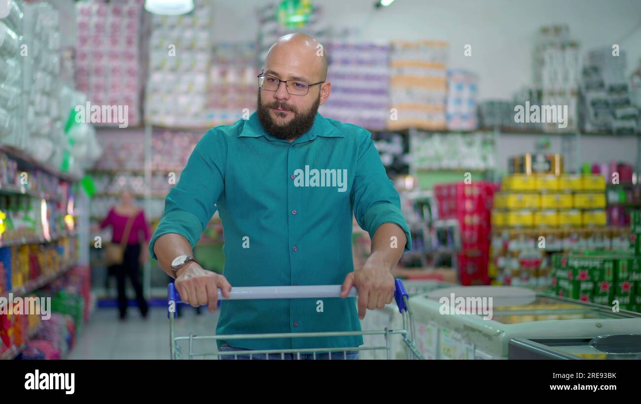 Male Customer Browsing Products in Grocery Store Aisle, Pushing ...