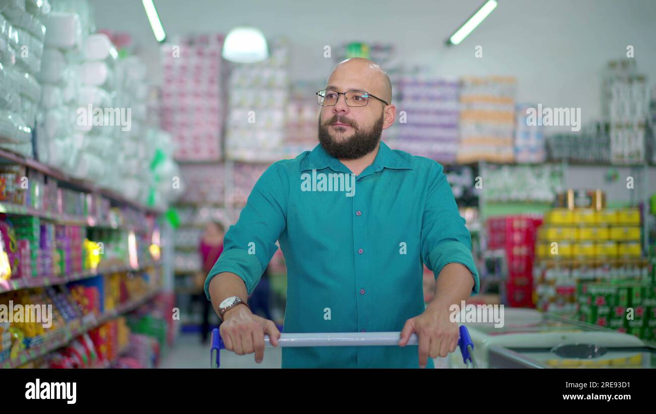 Male Customer Browsing Products in Grocery Store Aisle, Pushing ...