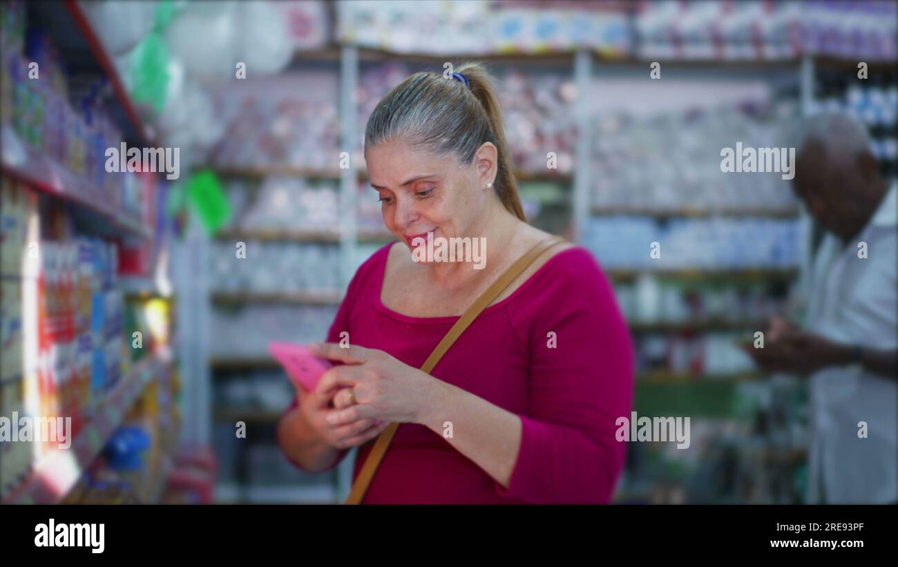 Female Shopper Cross-Checking Product Details Online Using Smartphone ...
