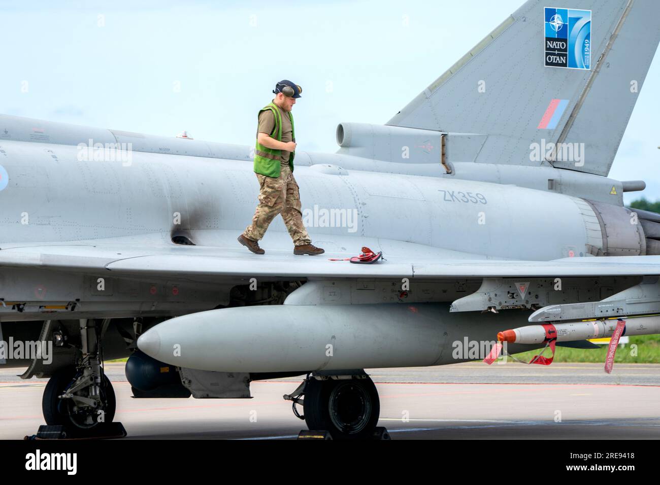 A member of the ground crew checks an RAF Typhoon jet after it's return ...