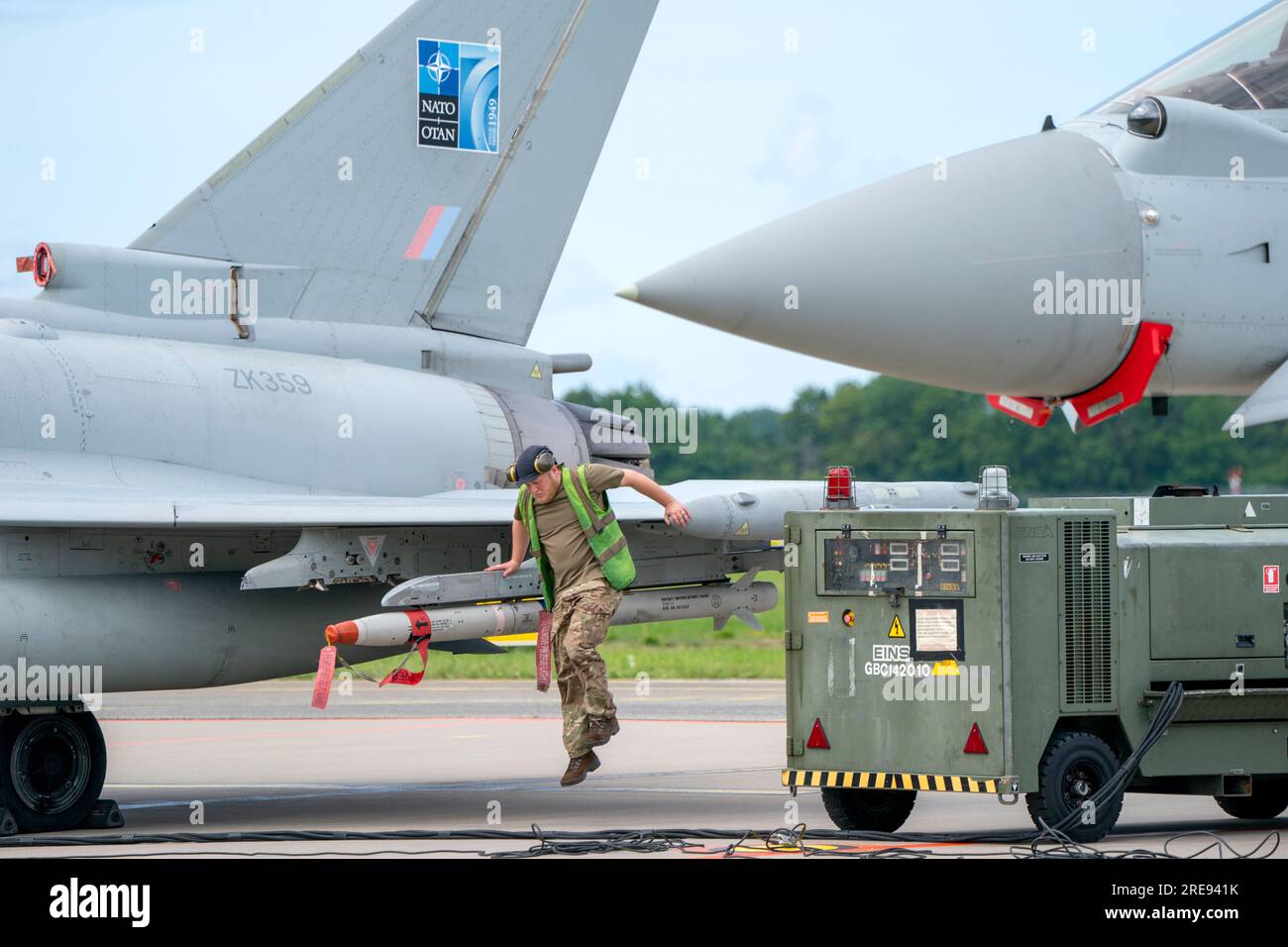 A member of the ground crew checks an RAF Typhoon jet after it's return ...