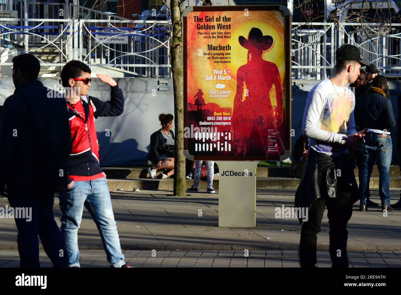 archival: Manchester, UK, 2014, young men, bright sunlight, poster ...