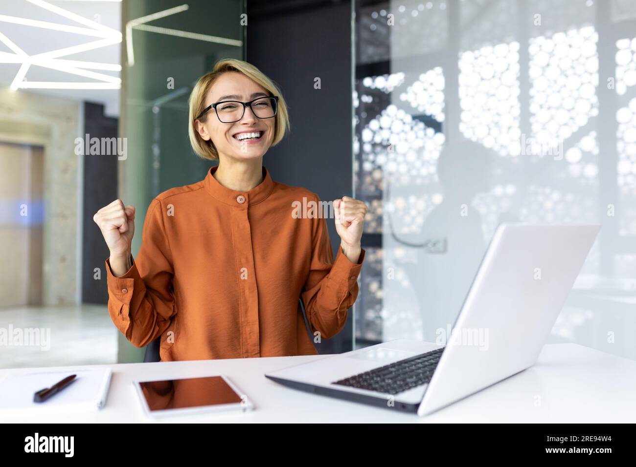 Young joyful business woman boss smiling and looking at camera ...